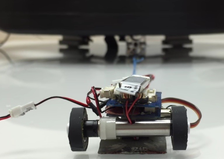 Watch These Tiny Robots Move a 2 Ton Car